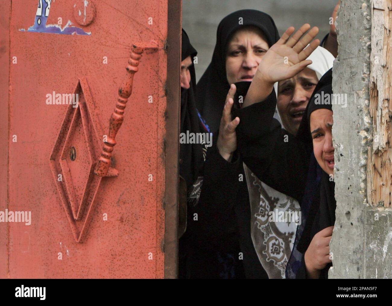 Palestinian relatives of Hamas militant Naim al-Arughi react during his ...