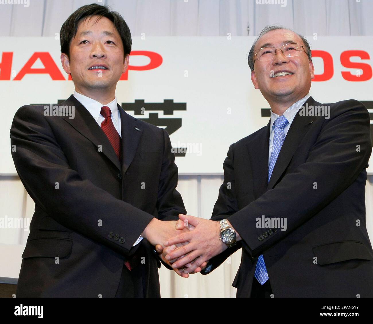Sharp Corp. President and COO Mikio Katayama, left, and Toshiba Corp ...
