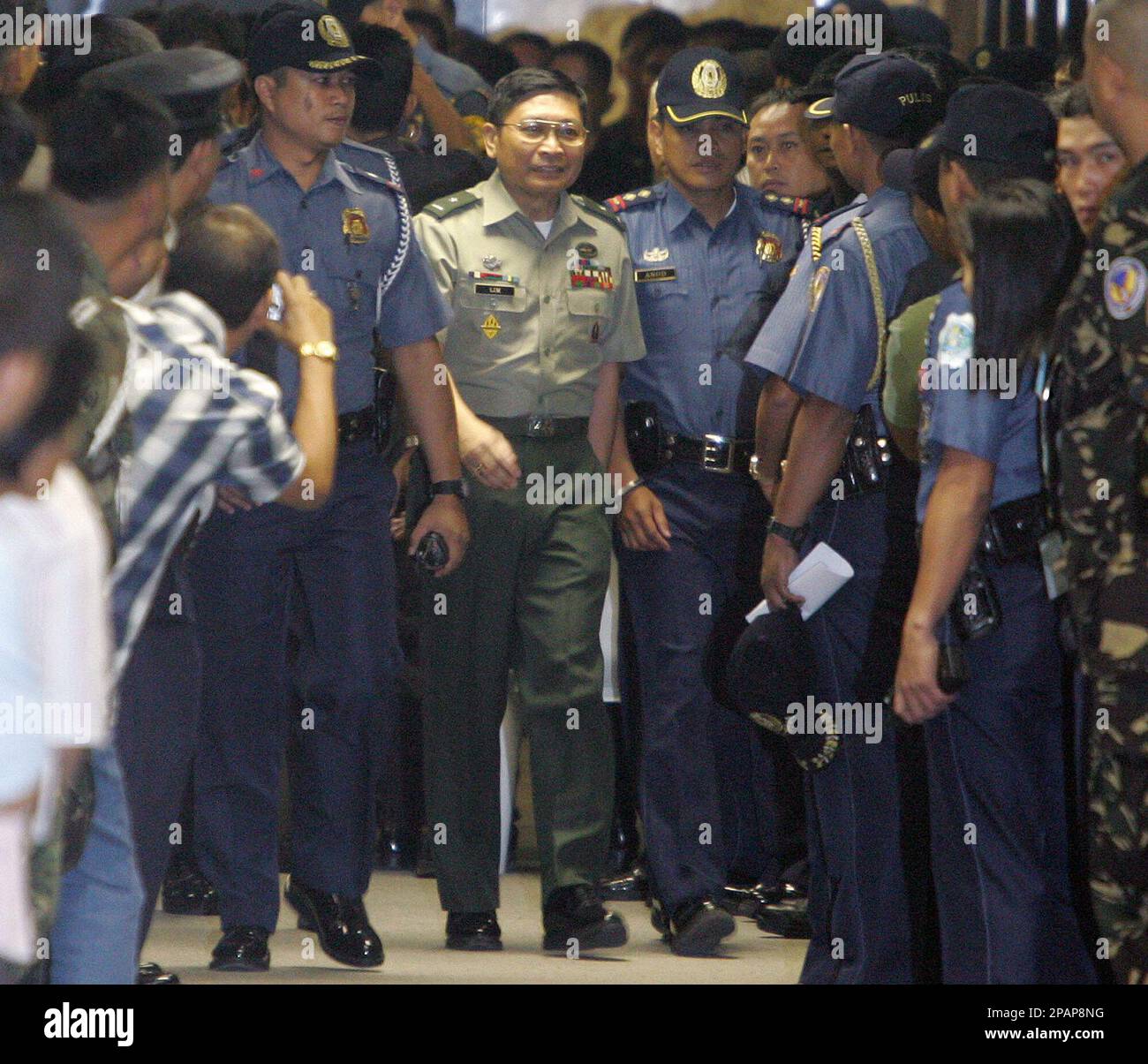 Philippine Army Brig. Gen. Danilo Lim, center, arrives under tight ...
