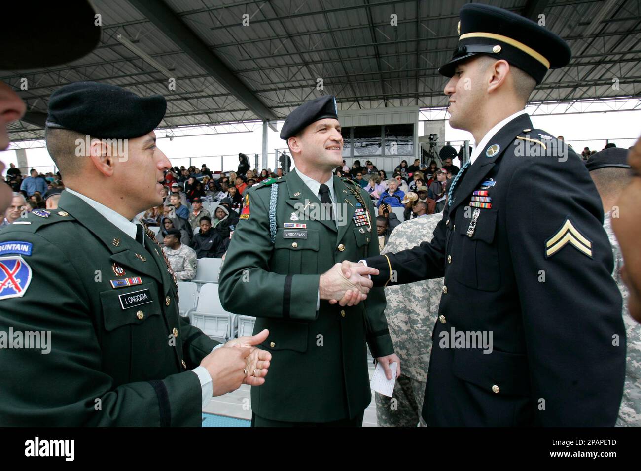 Spc. Alejandro "Alex" H. Albarran, Jr.right, is welcomes by 2nd ...