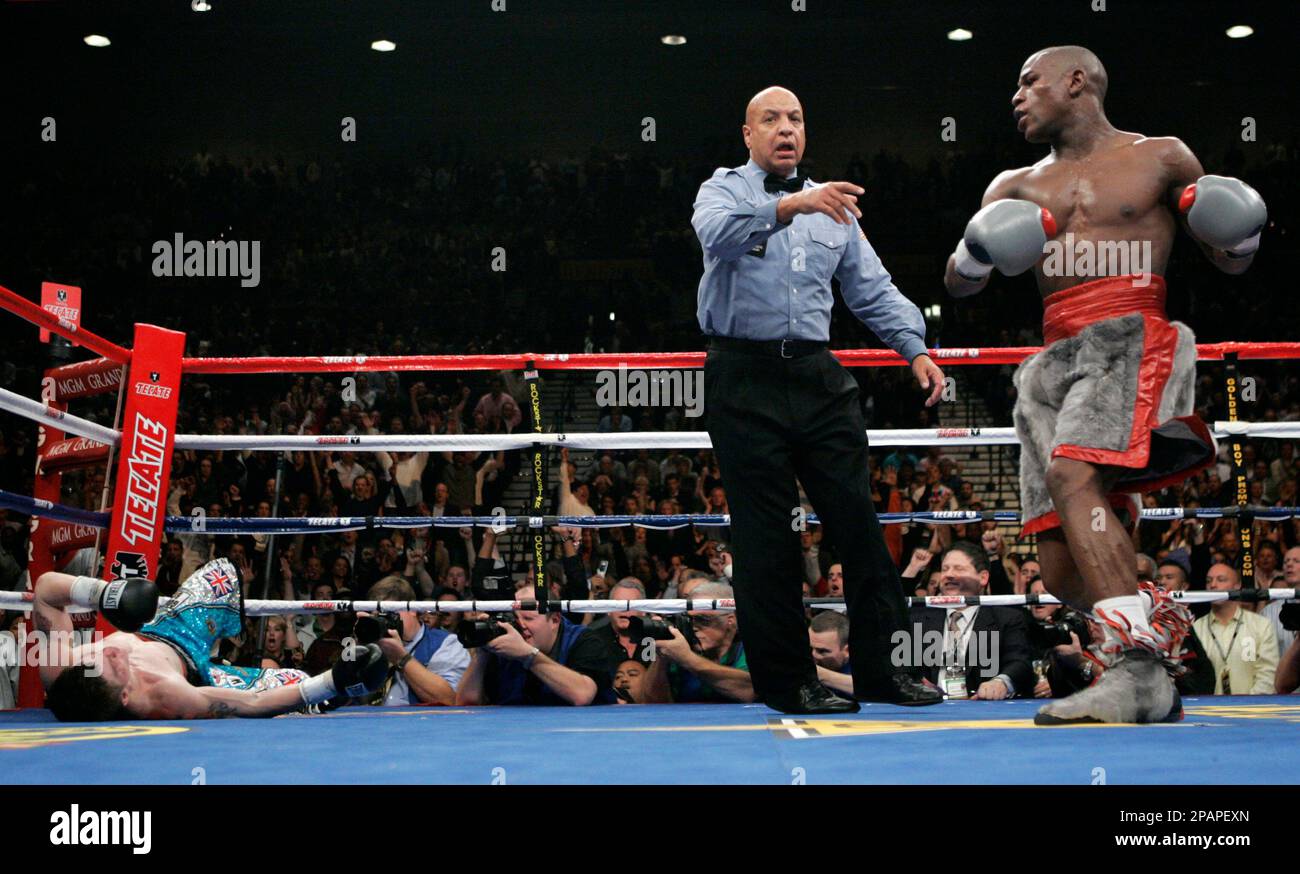 Floyd Mayweather Jr., right, is directed by referee Joe Cortez to a ...