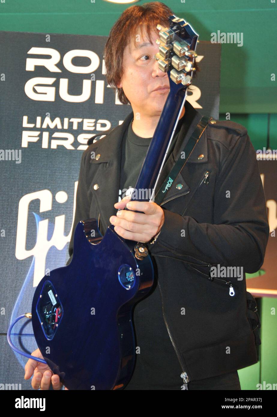 Japanese musician Ichiro Tanaka shows the back of Gibson's new product ...