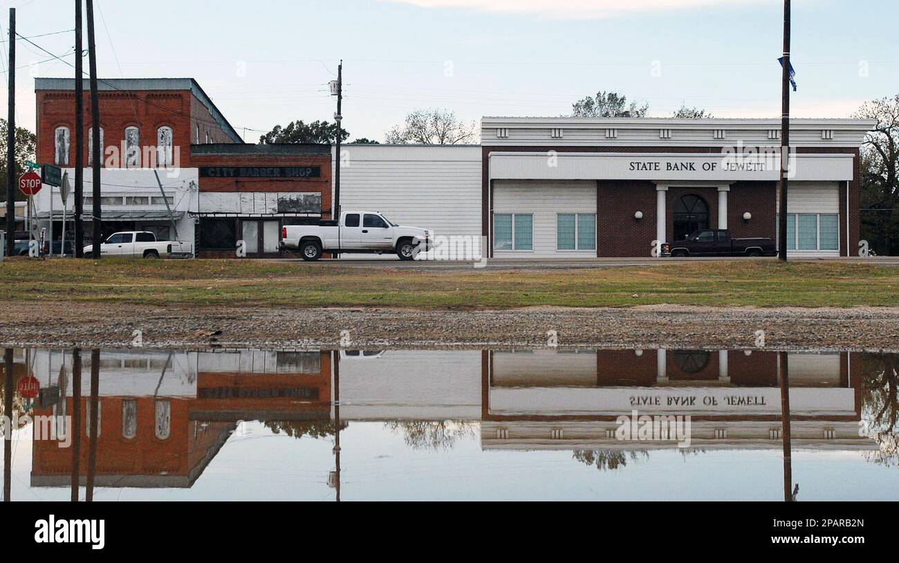A section of South Main street is reflected in a pool of water located ...