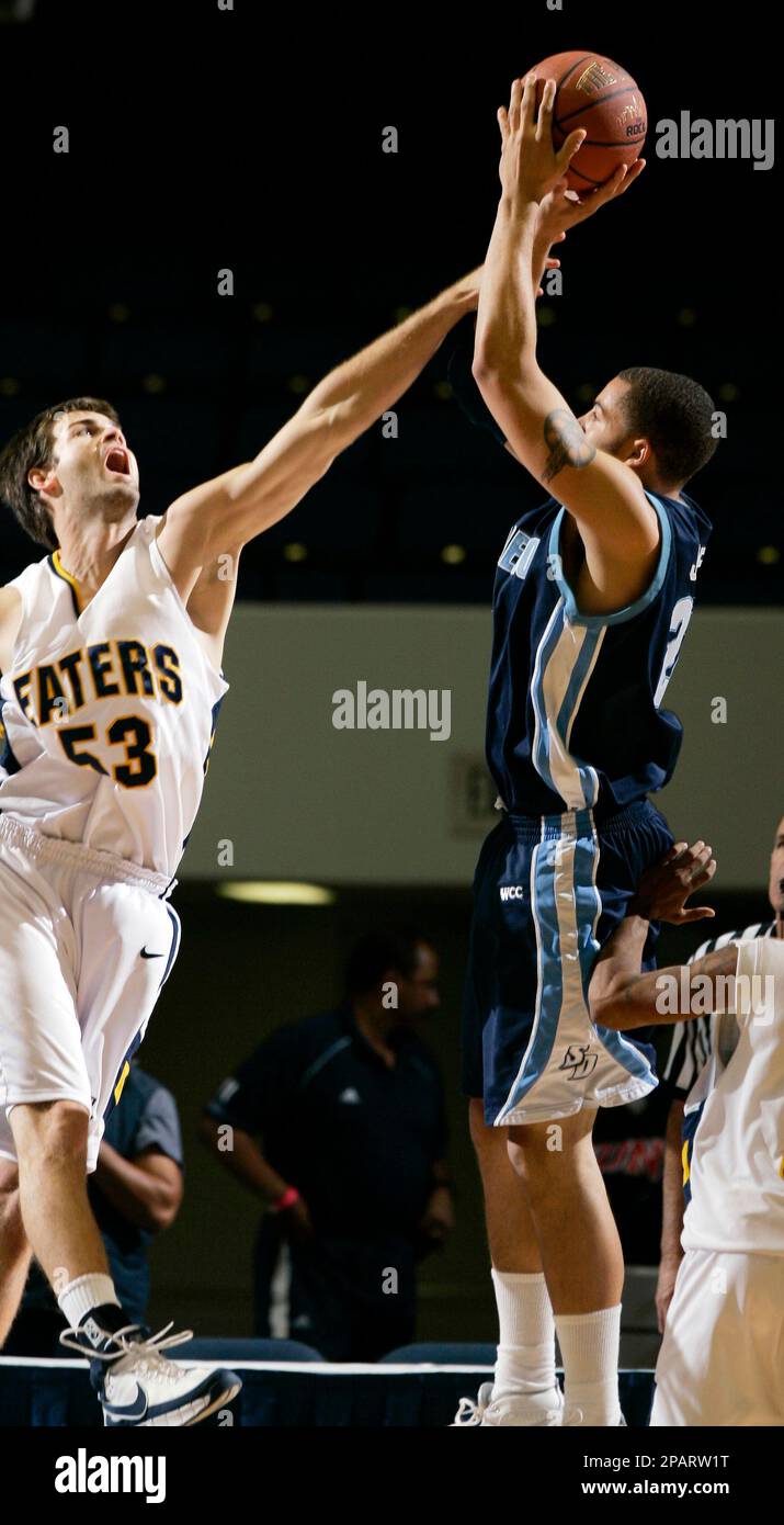 San Diego's Gyno Pomare, right shoots as UC Irvine's Kevin Bland guards ...