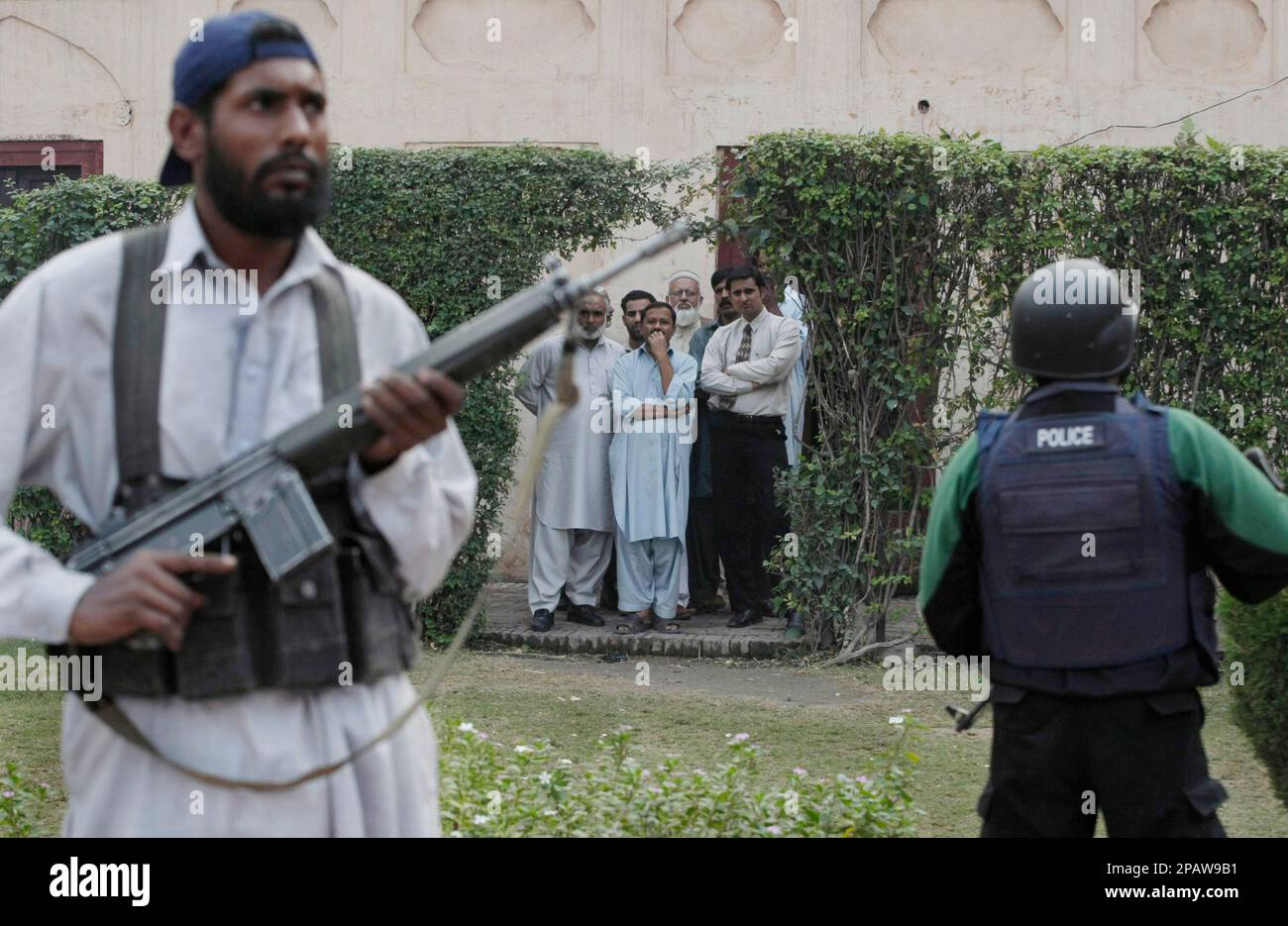 Security guard the area as supporters of Benazir Bhutto try to get a ...