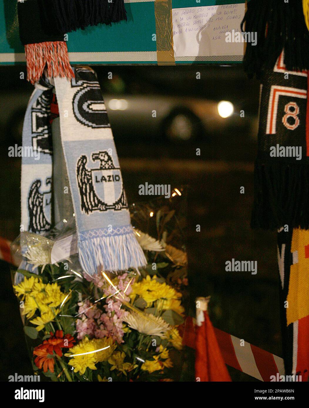 A Lazio soccer team's scarf and a bunch of flowers are laid at the ...