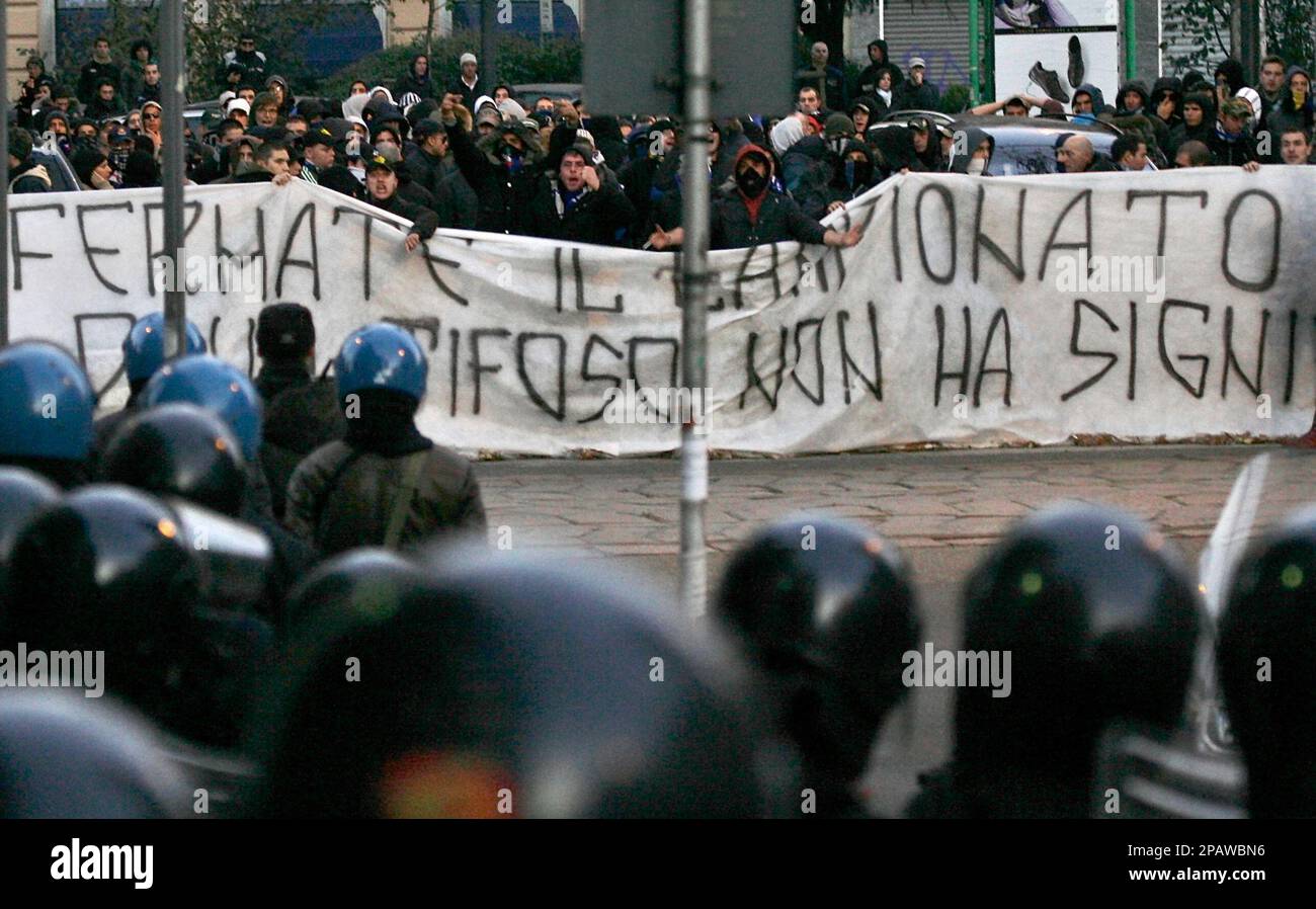 Soccer fans face police as they stage a protest in front of the Italian ...