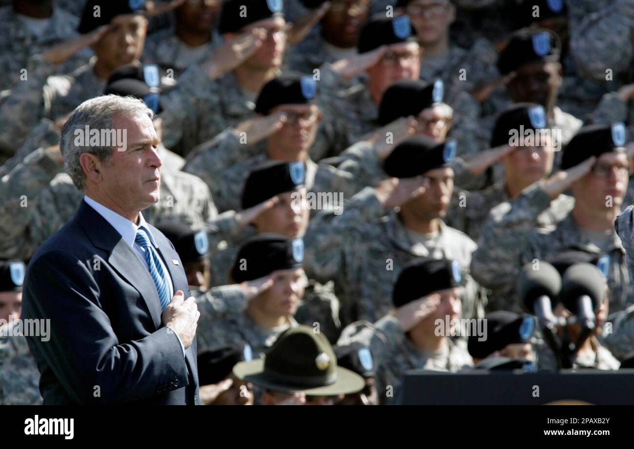 President Bush holds his hand to his heart as the National Anthem is ...