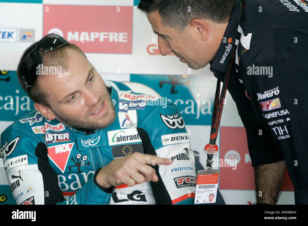 Bancaja Aspar Team rider Gabor Talmacsi from Hungary, left, speaks with ...