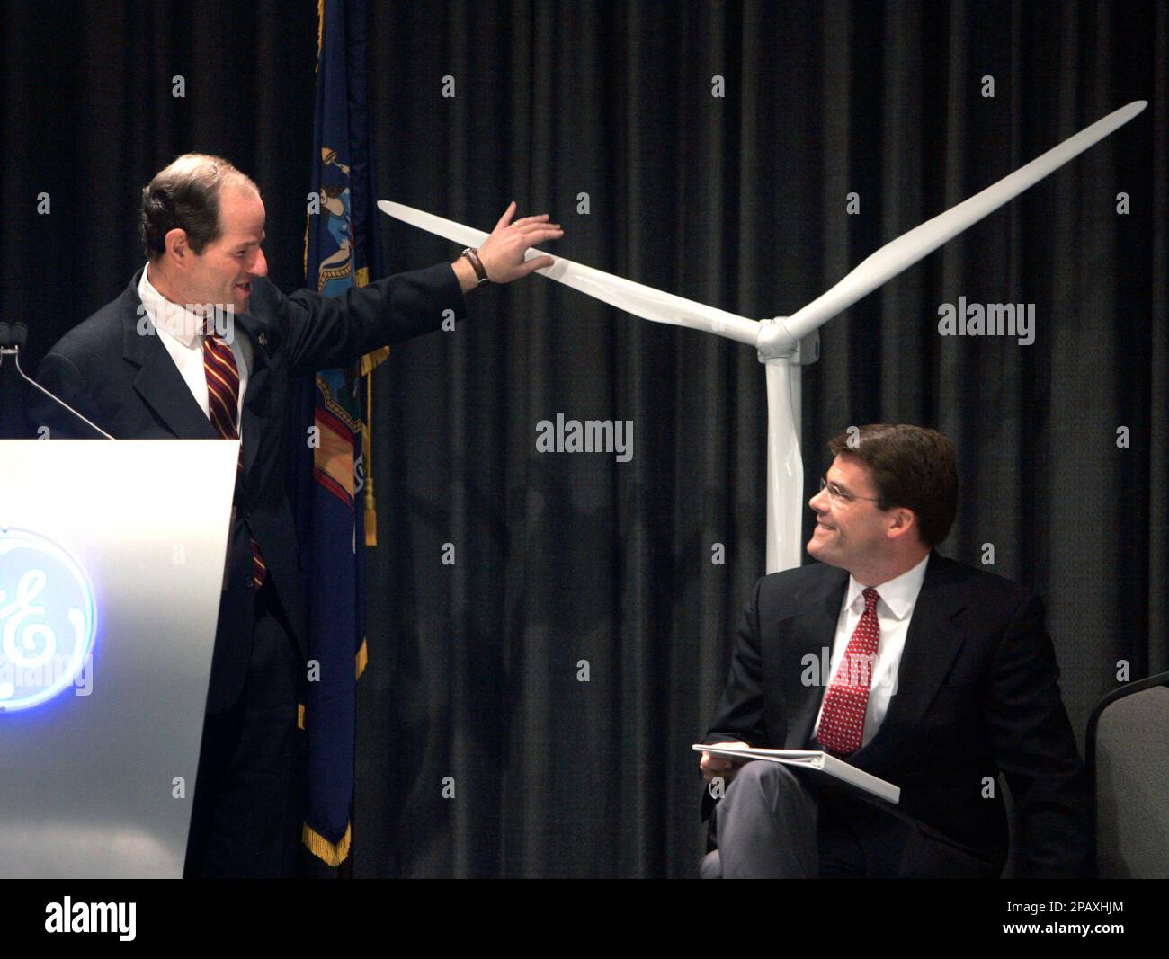 New York Gov. Eliot Spitzer, left, moves a rotor blade on a model wind ...