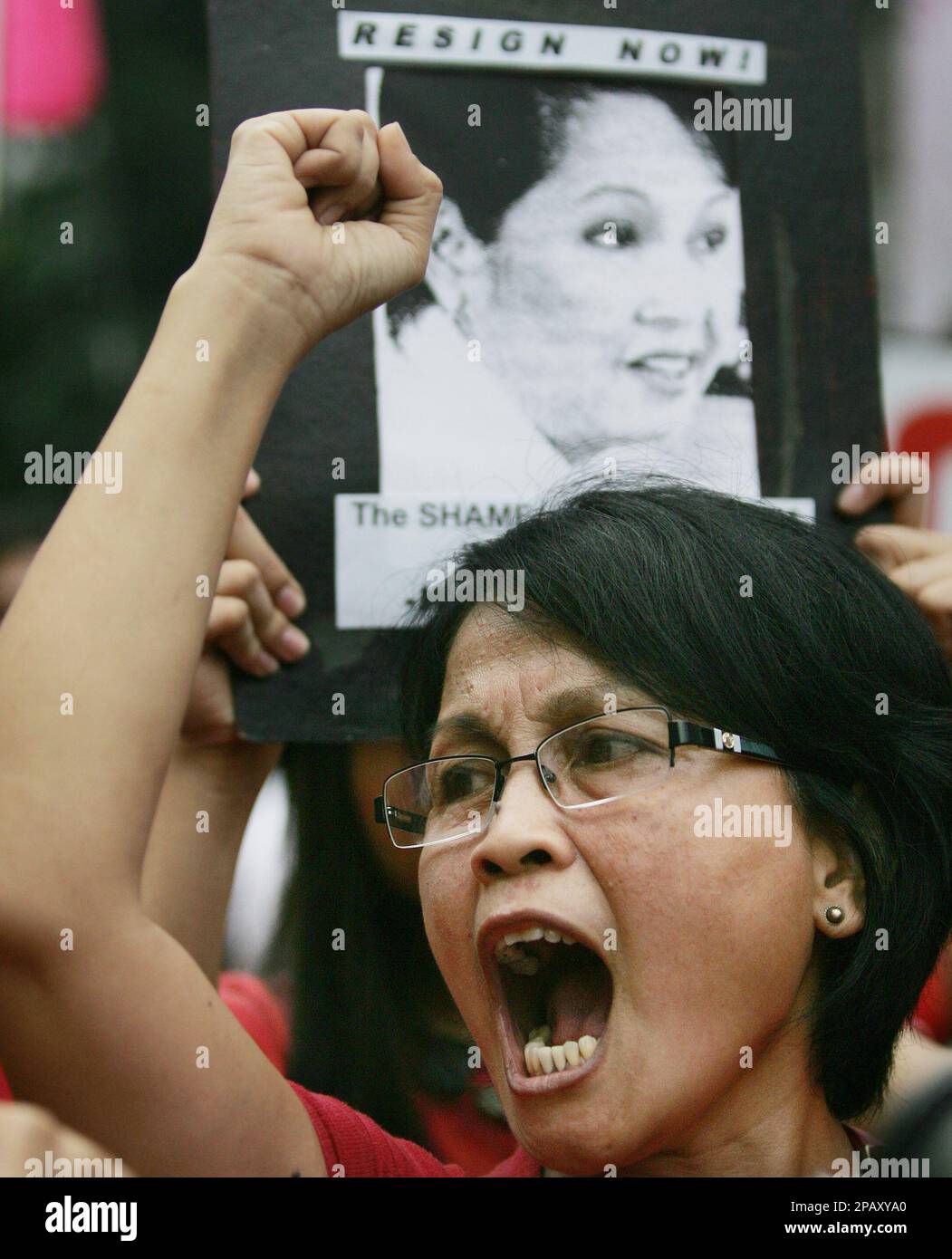 A Filipino woman activist shouts slogans as she and other protesters ...