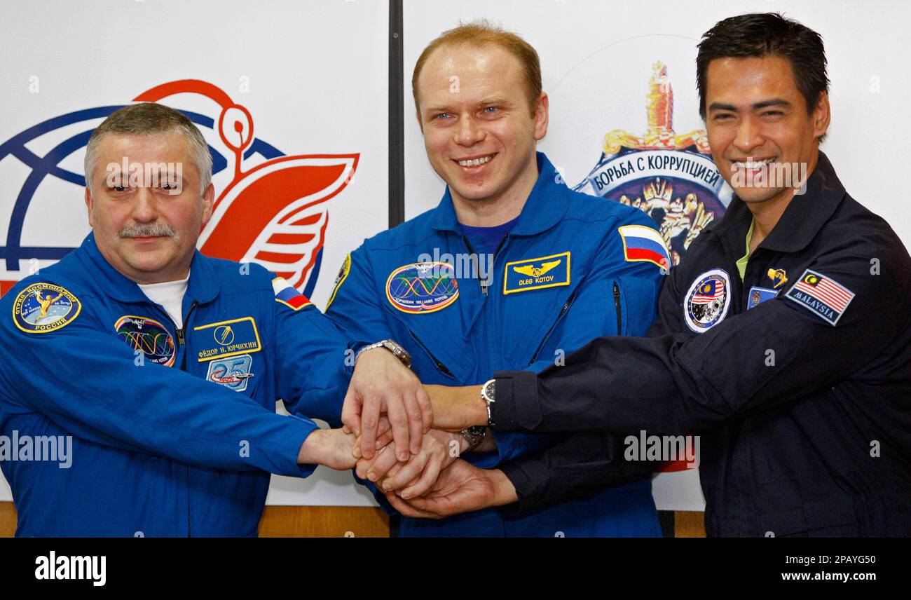 Malaysia's first space traveler Sheikh Muszaphar Shukor, right, Russian ...
