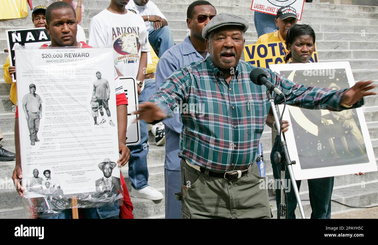 Standing along side family members holding up a sign posting a $20,000 ...
