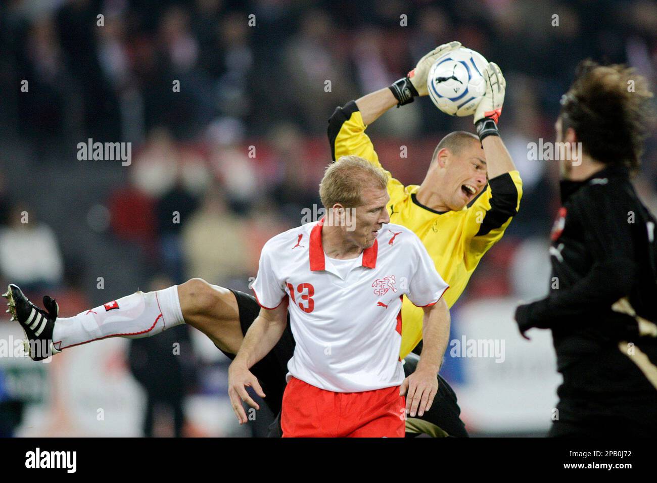 Swiss goalkeeper Fabio Coltorti, center, takes the ball in front of ...