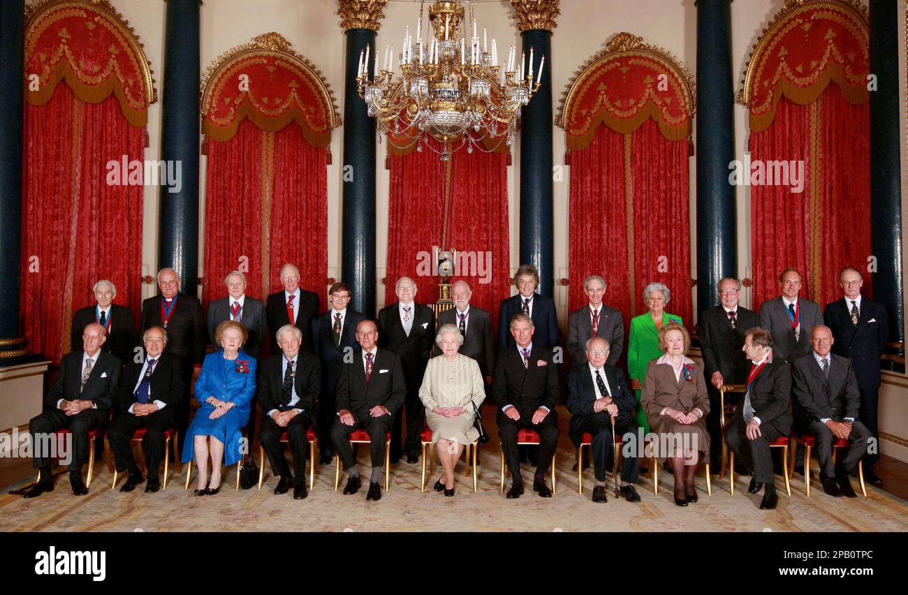 Britain's Queen Elizabeth II poses with the recipients of the Order of ...