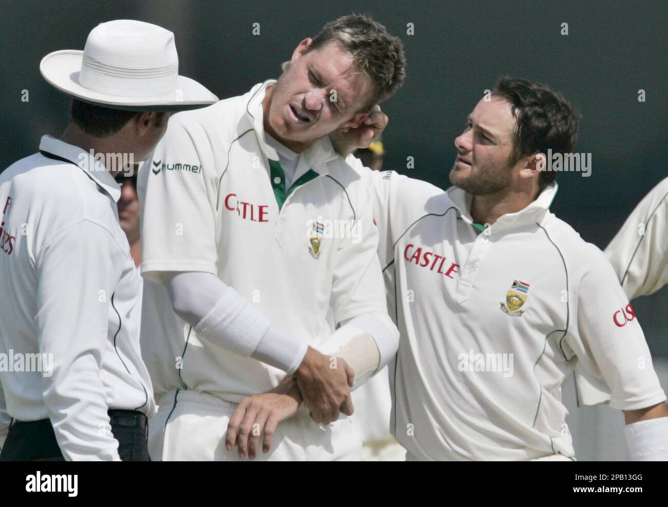 South African batsman Mark Boucher, right, examines the ear of his ...