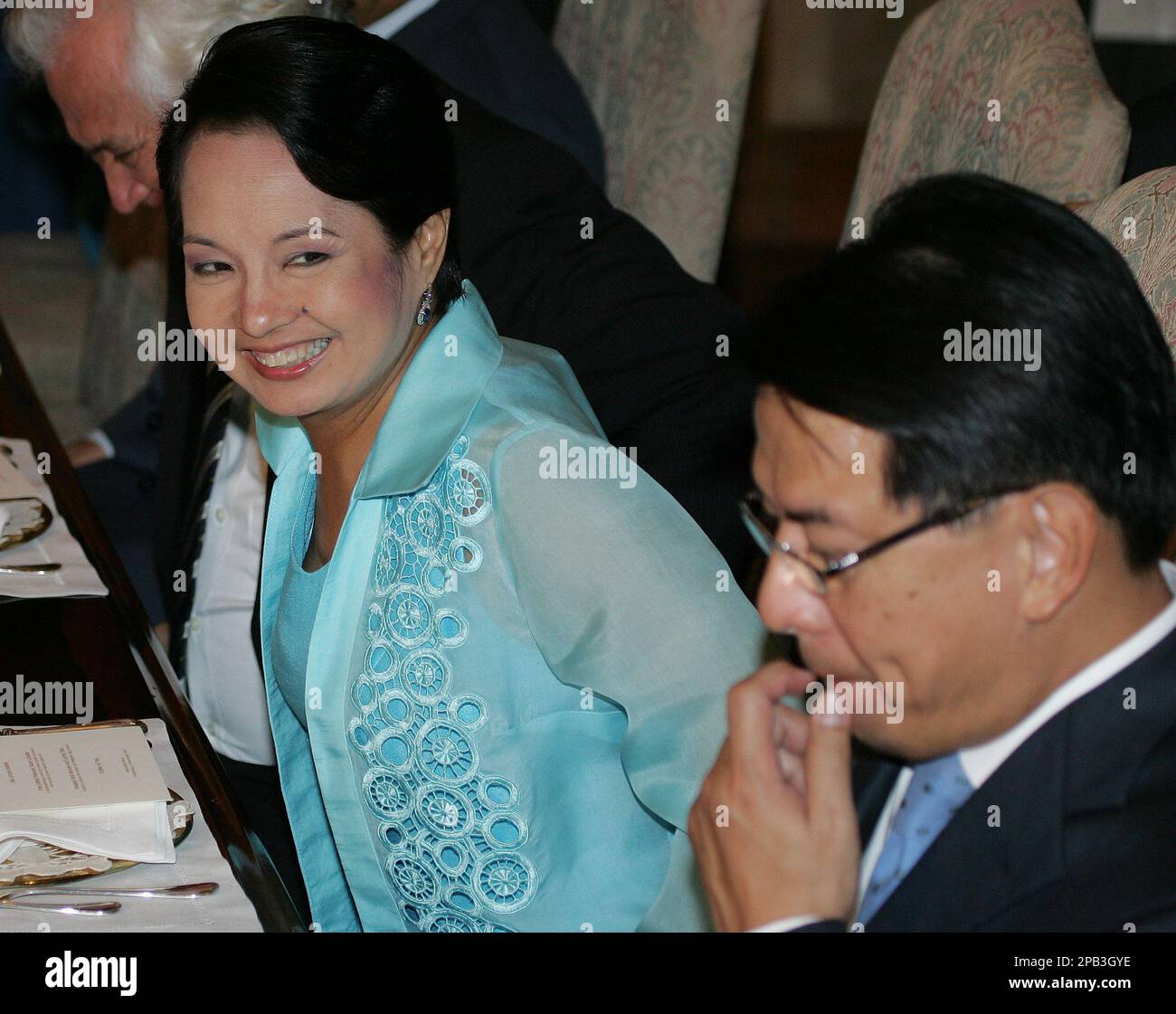 Philippine President Gloria Macapagal Arroyo, left, smiles beside ...