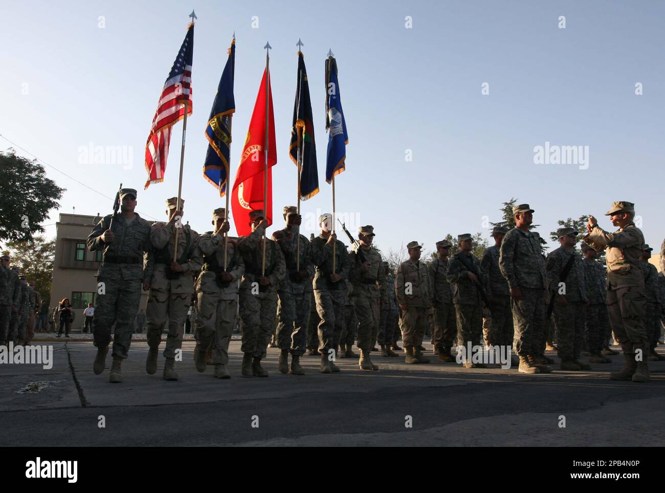 U.S. soldiers carry various flags during a ceremony to mark the sixth ...
