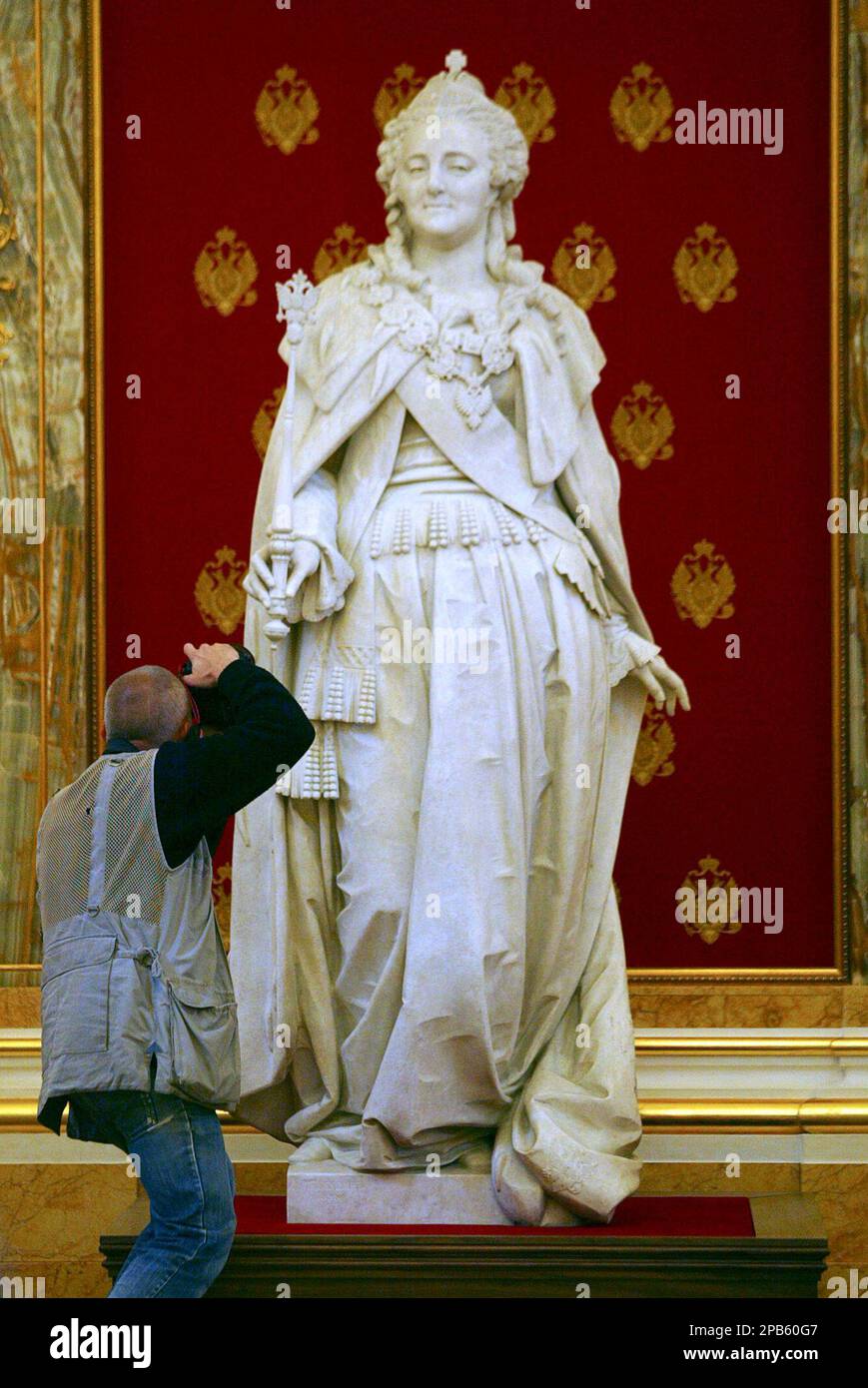 A man takes photo of the statue of empress Catherine the Great rising ...