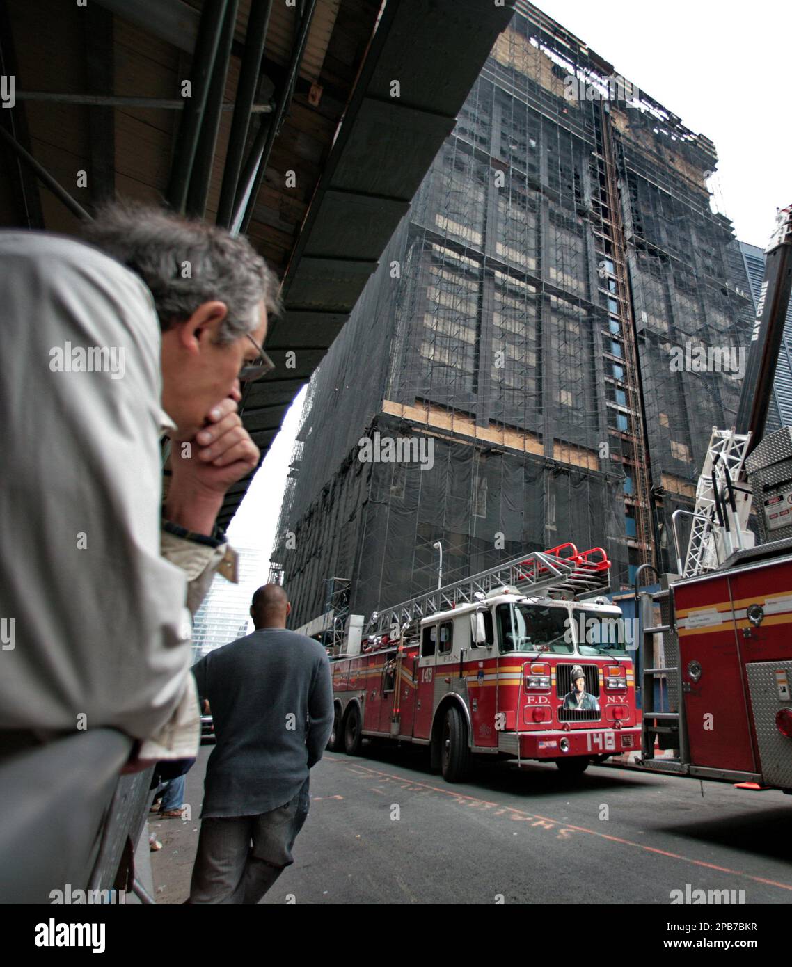 Onlookers stare at the Deutsche Bank building where worked has stopped ...
