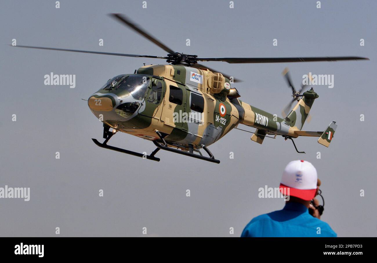 A cameraman films the new version of Dhruv helicopter during its flight ...
