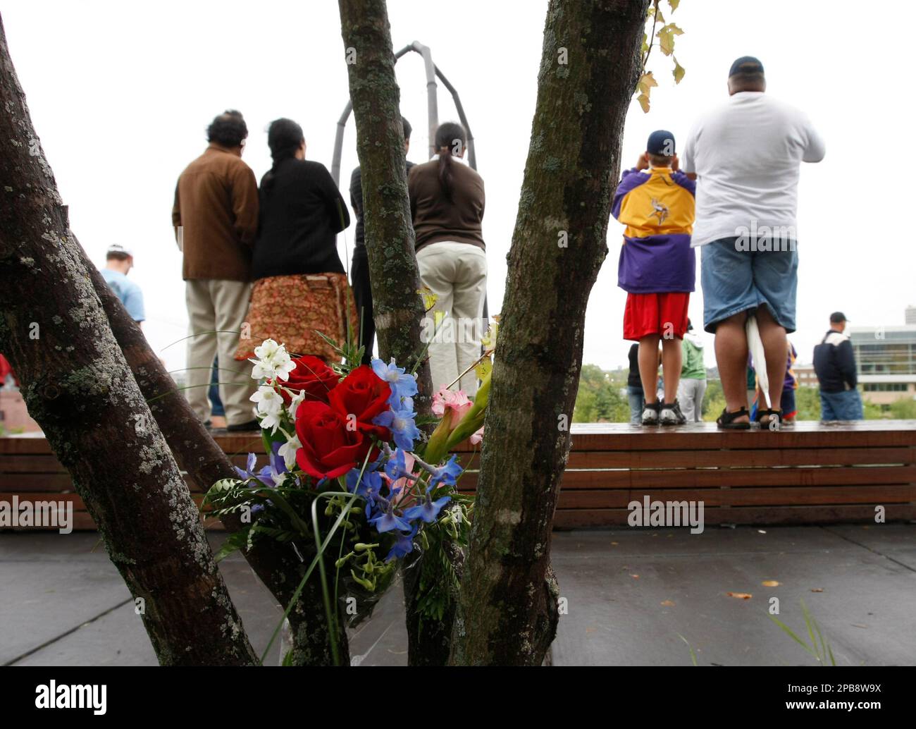 Flowers are placed in trees as a memorial to those lost in the collapse ...