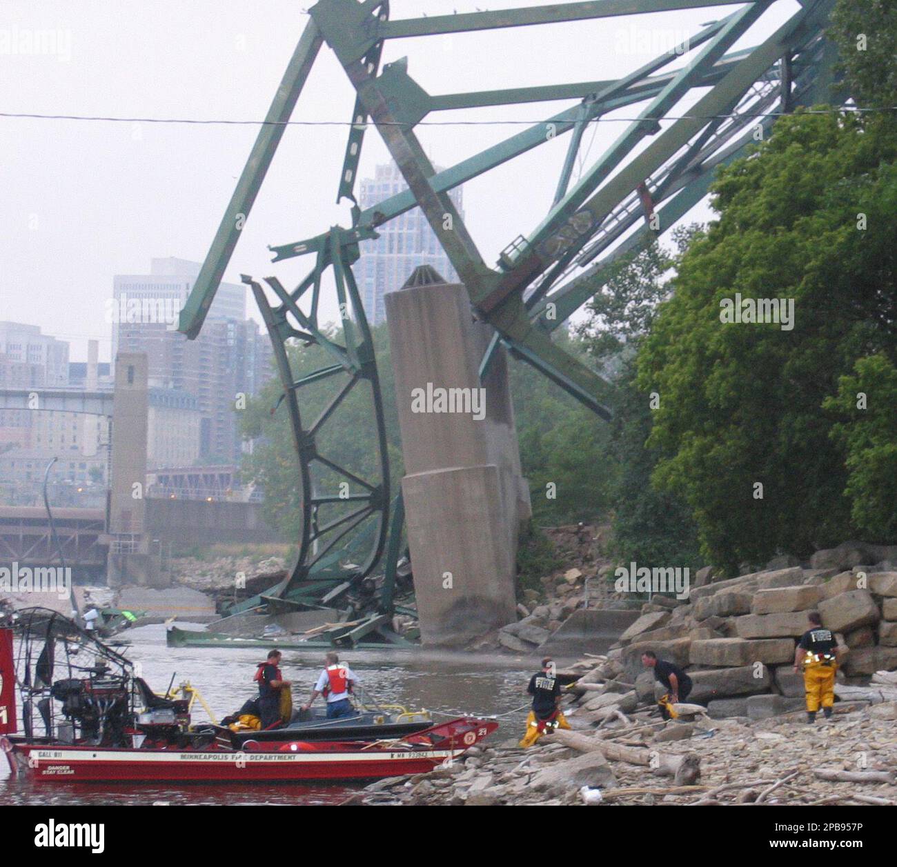 Emergency personnel respond at the scene of a freeway bridge collapse ...