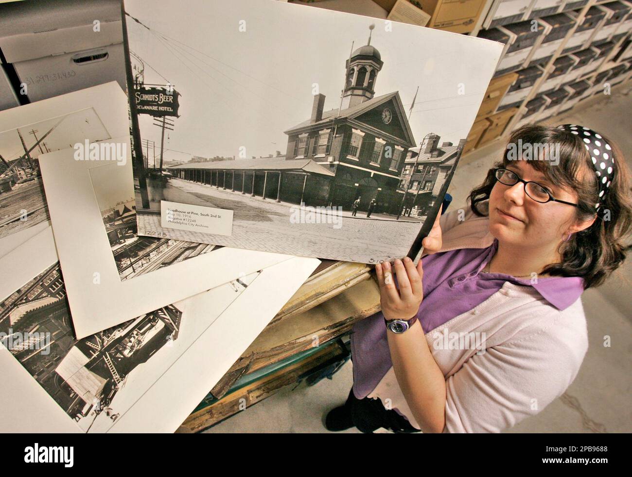Heather Newlin displays some of the photos which are scanned into ...