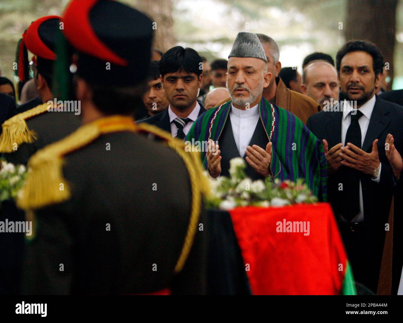 Afghan President Hamid Karzai, second right, pays his last respect as ...