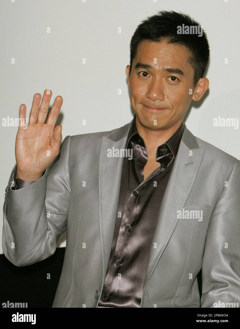 Hong Kong film star Tony Leung Chiu-wai waves at Japanese fans who have just seen one of his ...