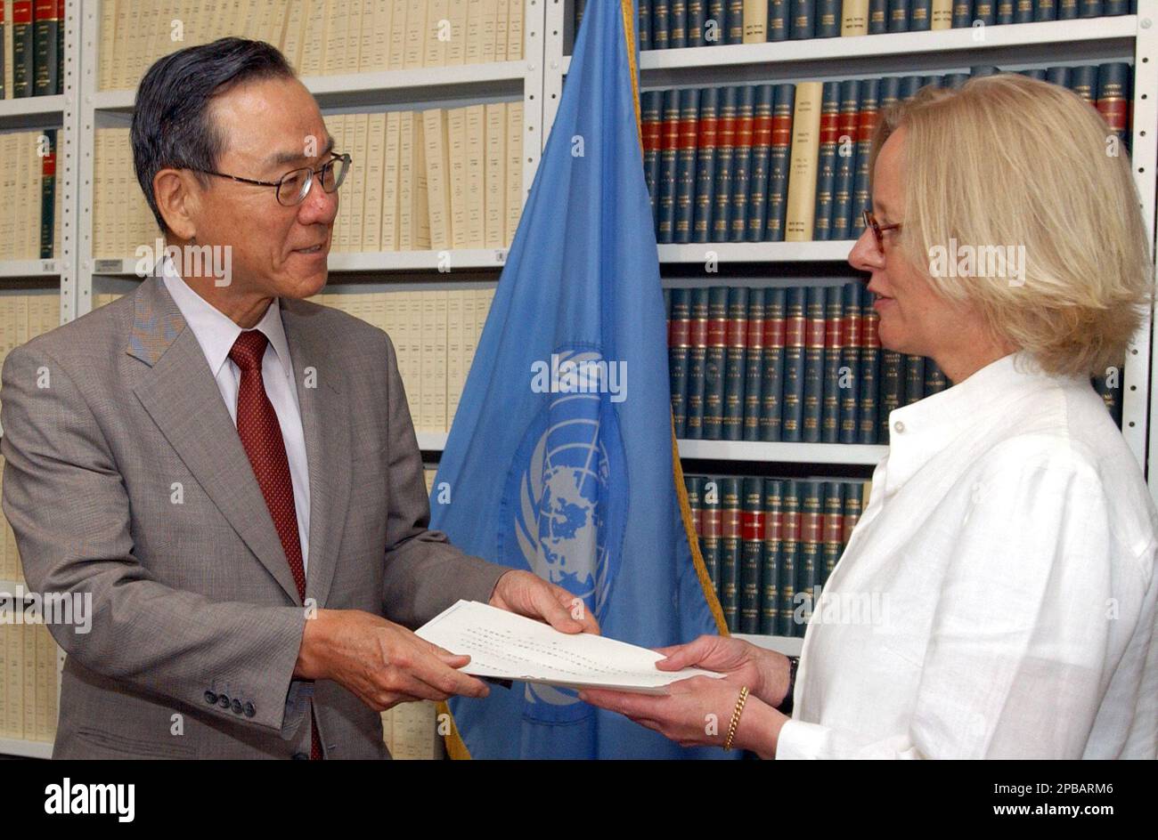 Japanese Ambassador to the United Nations Kenzo Oshima, left, presents ...