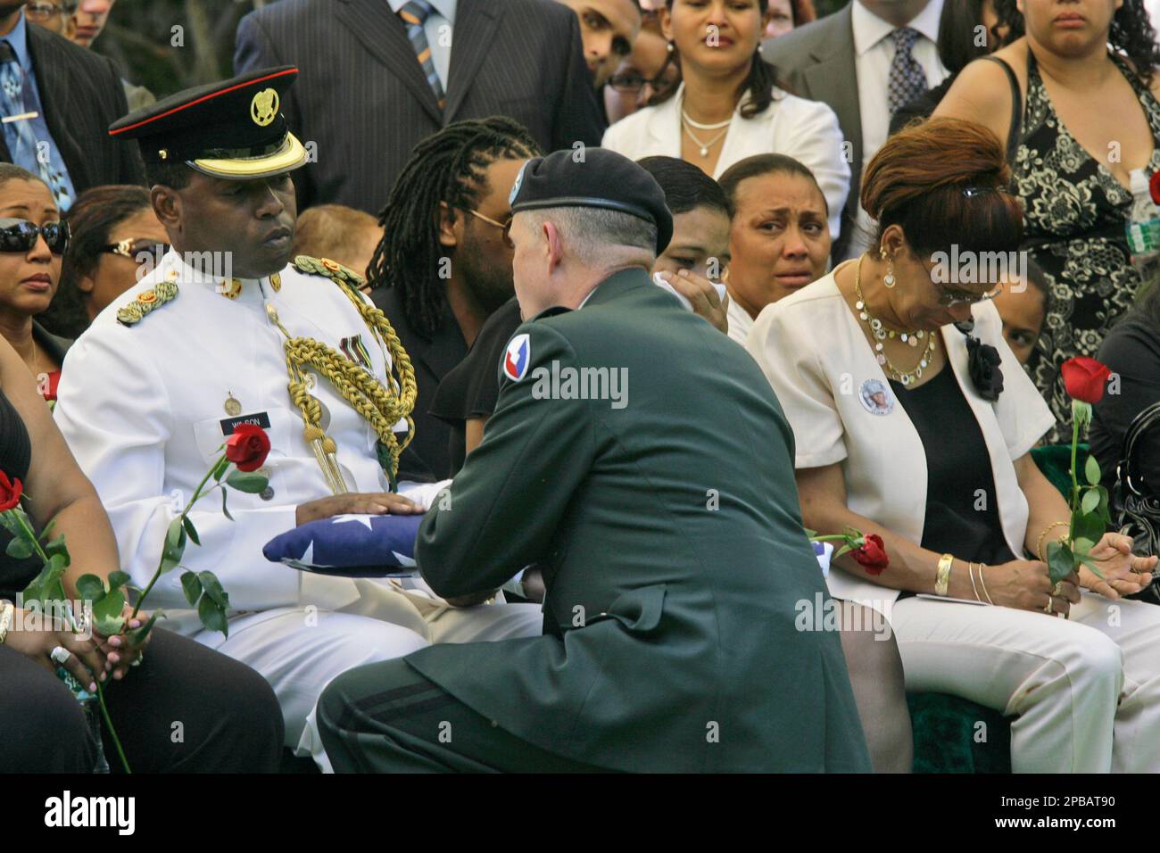 Lawrence Wilson , father of PFC Le Ron Wilson is presented with the ...
