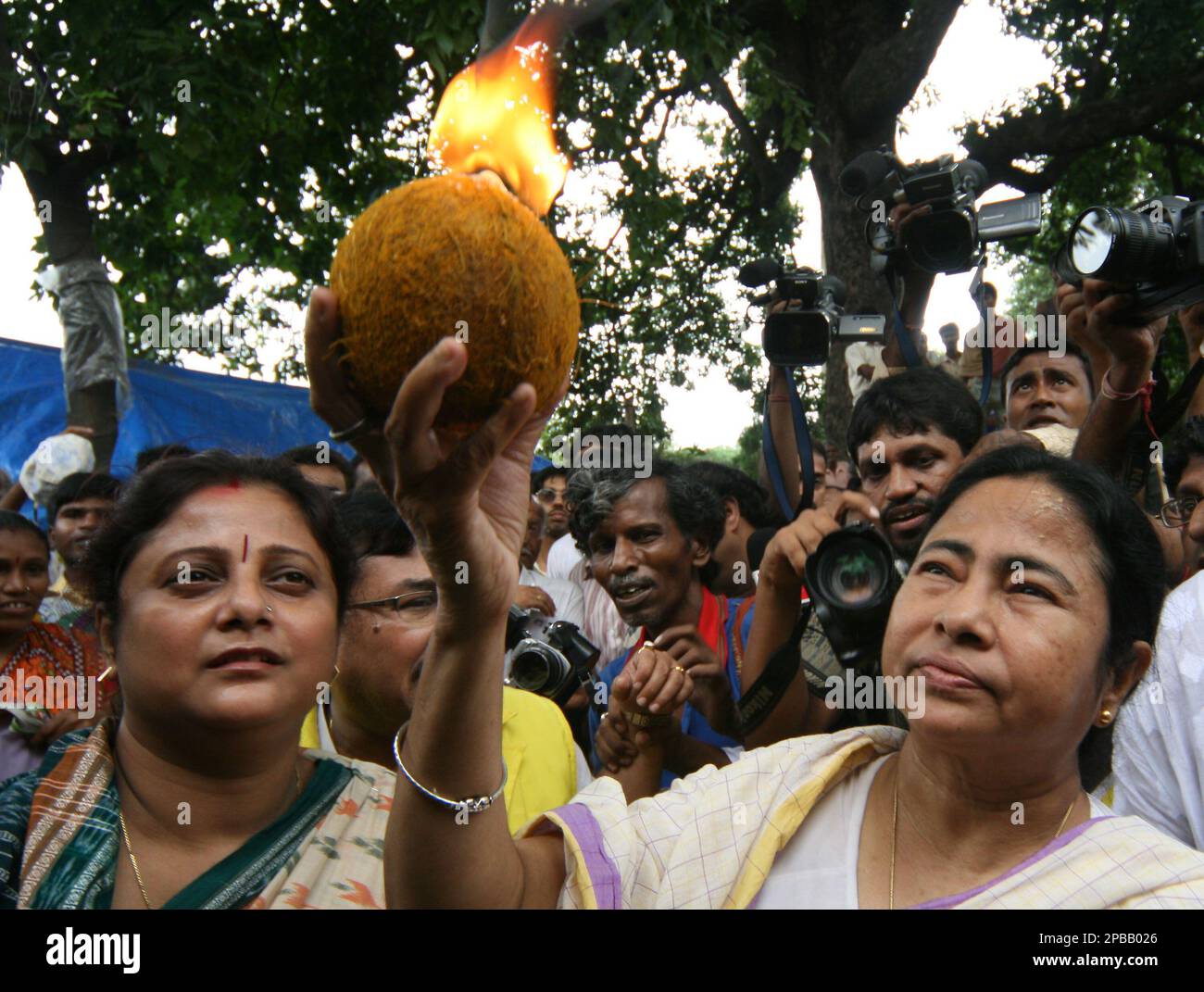 Trinamul Congress party leader Mamata Banerjee, right, performs a religious ritual before the ...