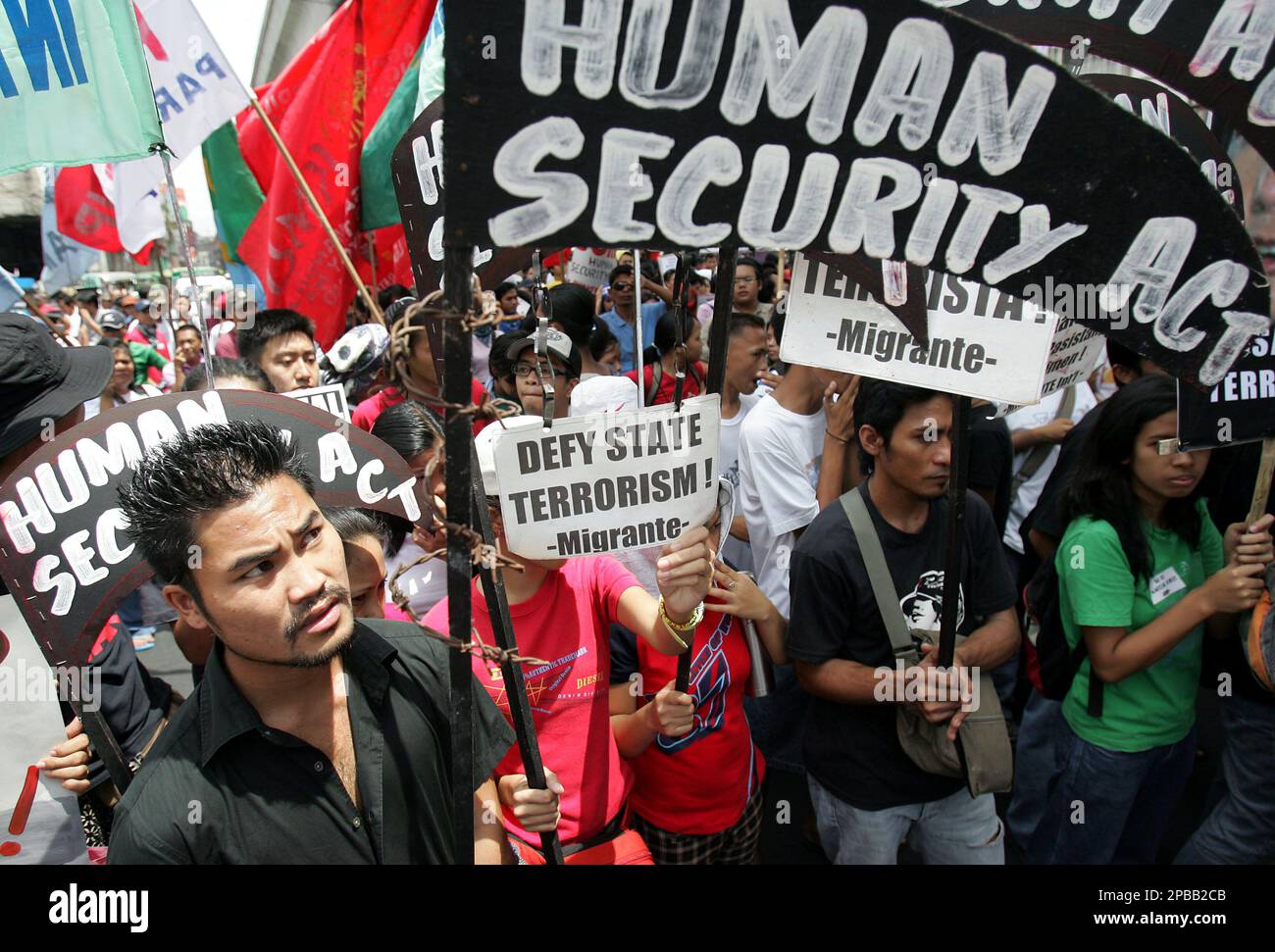 Filipino activists hold placards and banners with slogans during a ...