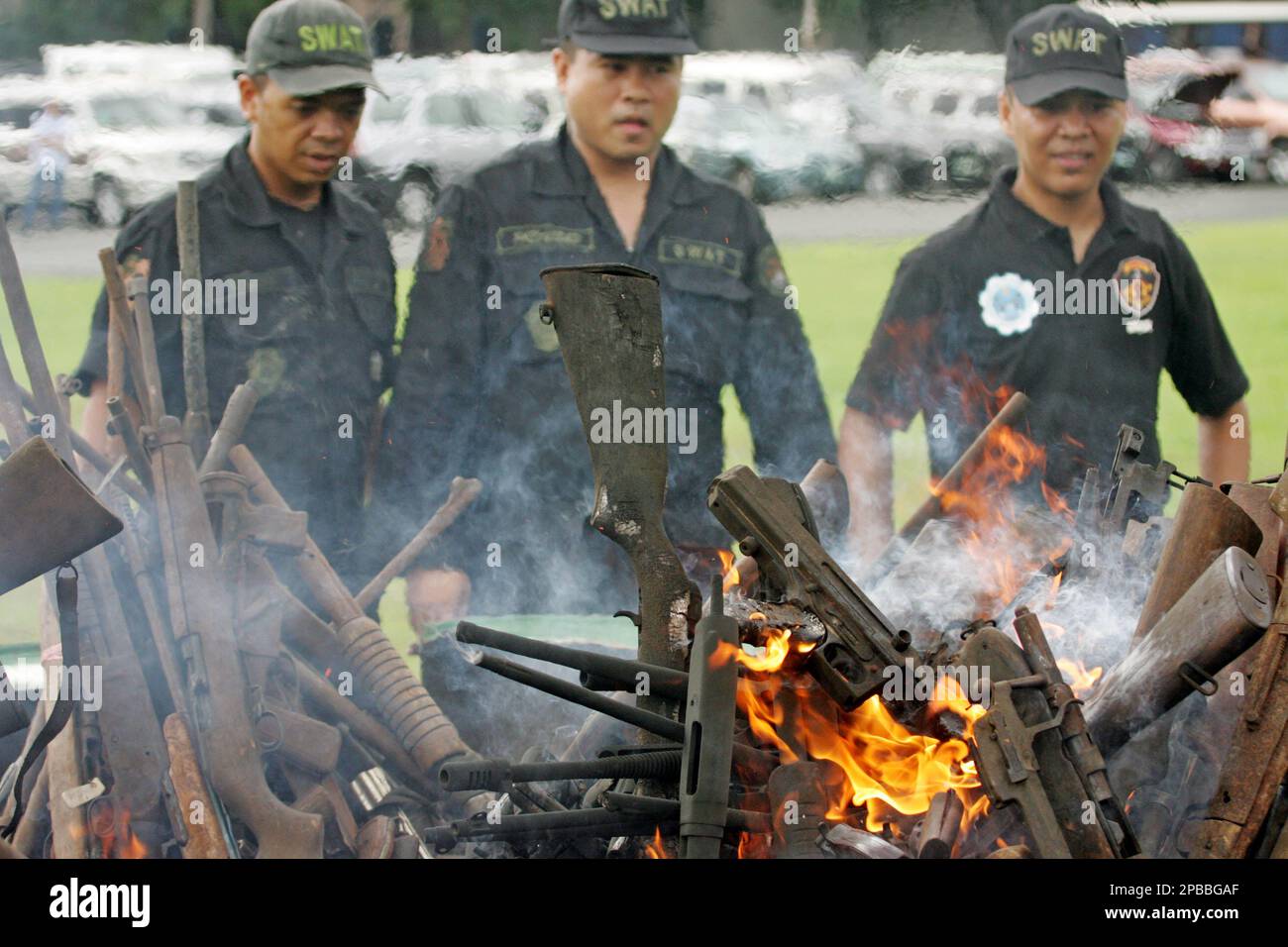 SWAT members of the Philippine National Police stand close to a pile of ...