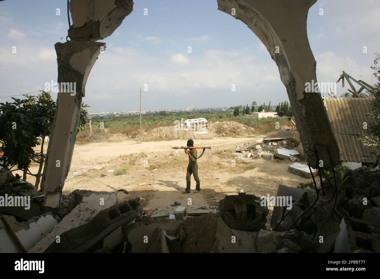 A Palestinian masked gunman of Hamas group holds his rocket propelled ...