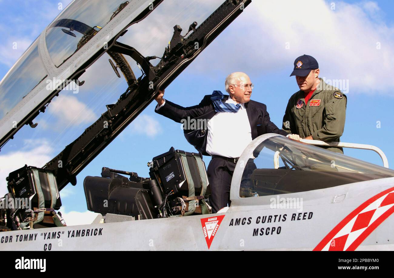 Australian Prime Minister John Howard, left, is shown a cockpit of a ...