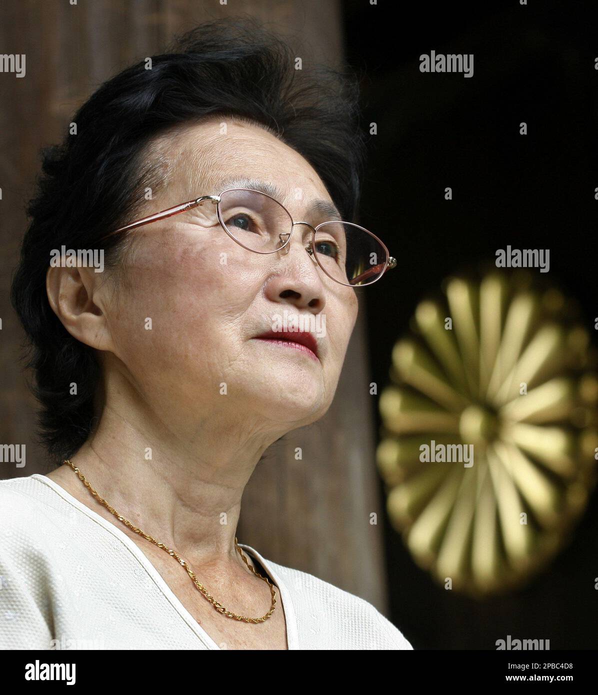 **FILE**Yuko Tojo walks past a gate decorated with the chrysanthemum emblem in this June 5, 2007 ...