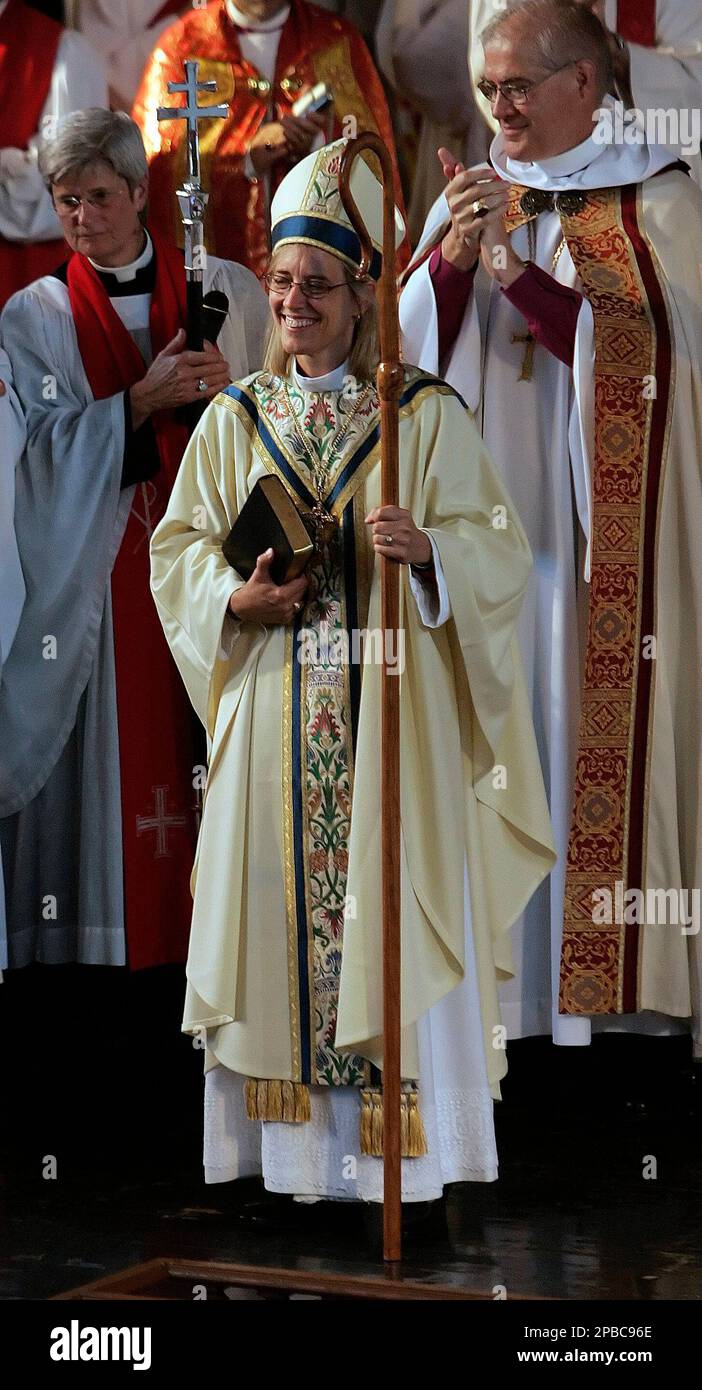 The Rev. Laura J. Ahrens smiles as she is applauded by clergy and the ...