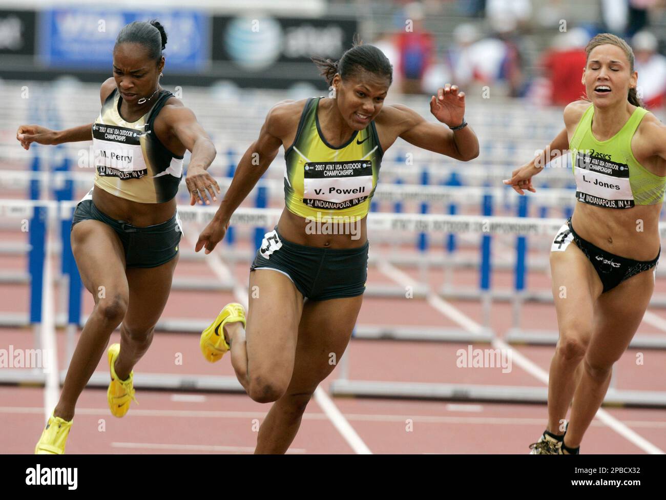 Virginia Powell, center, lunges for the finish line ahead of Michelle ...