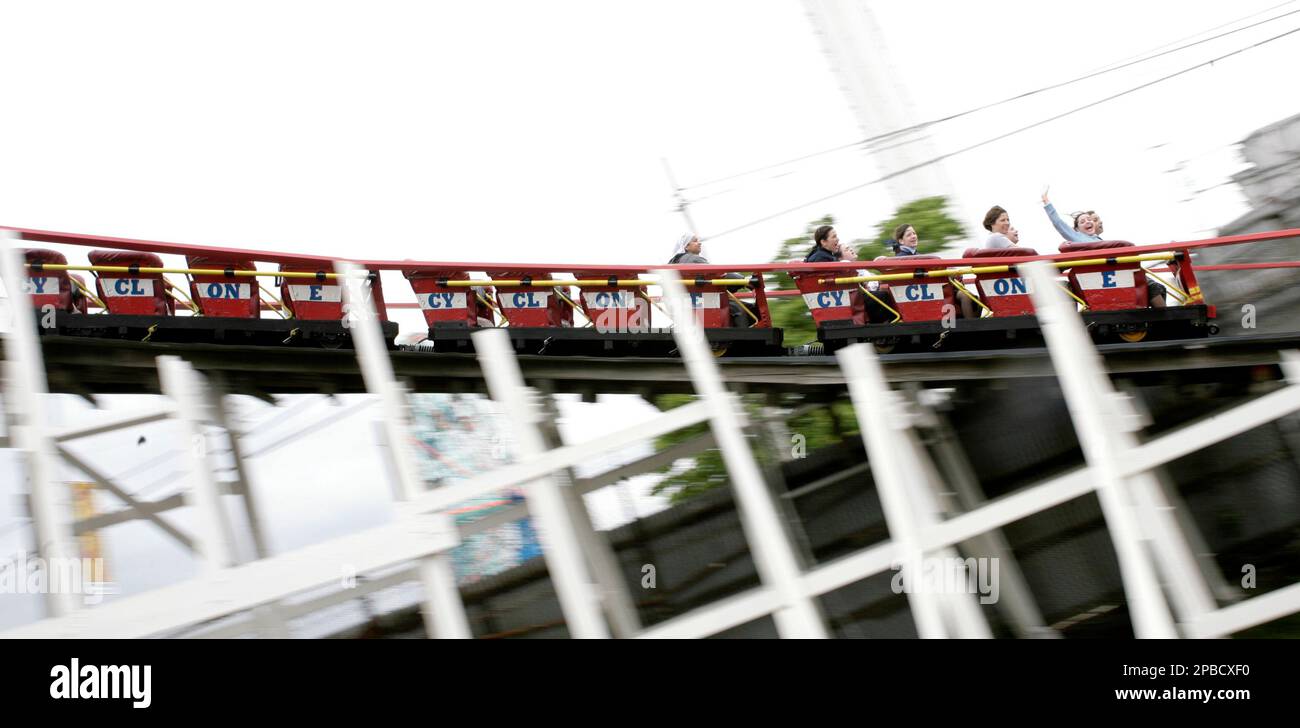 Riders on the Cyclone roller coaster move past at speeds up to 60 m.p.h ...