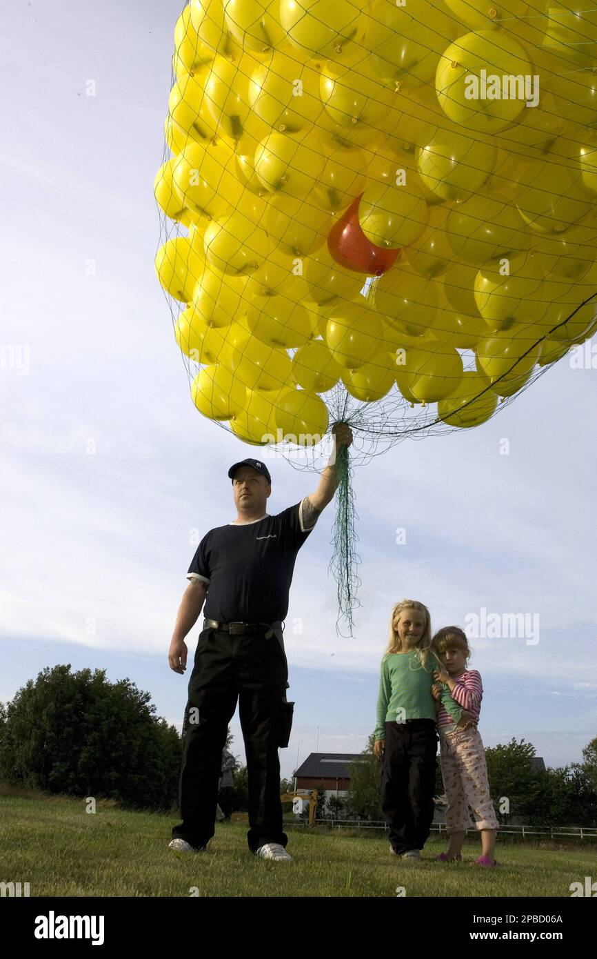 Ronnie Pedersen, left, holds 500 balloons which he released Friday June ...