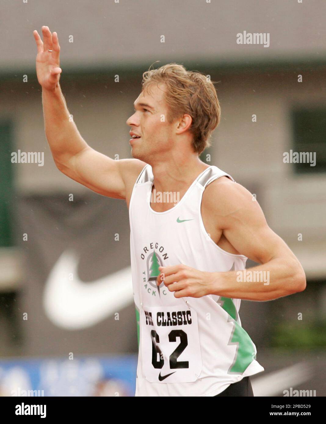 ** FILE ** Nick Symmonds waves to the crowd during his victory lap ...