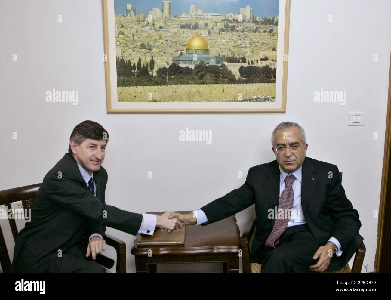Newly-appointed Palestinian Prime Minister Salam Fayyad, right, shakes ...