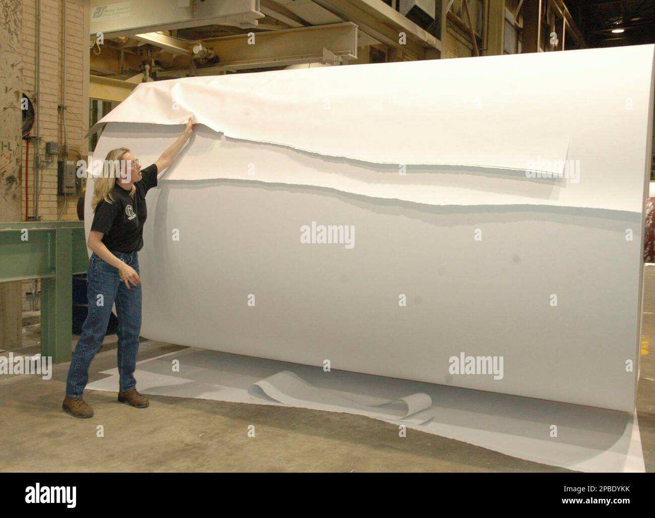 Tricia Pendergraft tears strips from a paper roll on May 4, 2007 at a ...