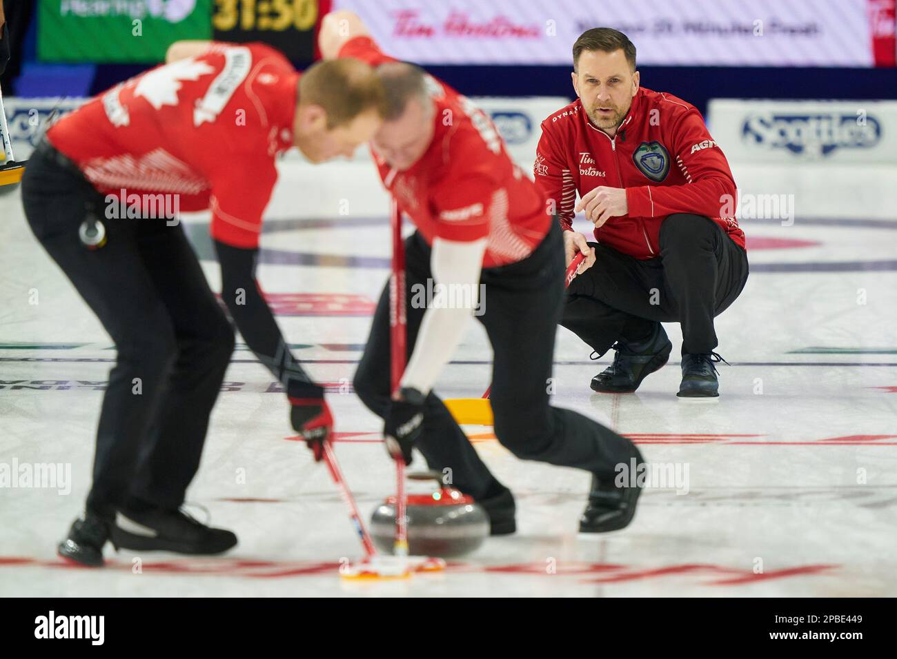Team Canada skip Brad Gushue, right, watches his sweepers during the ...