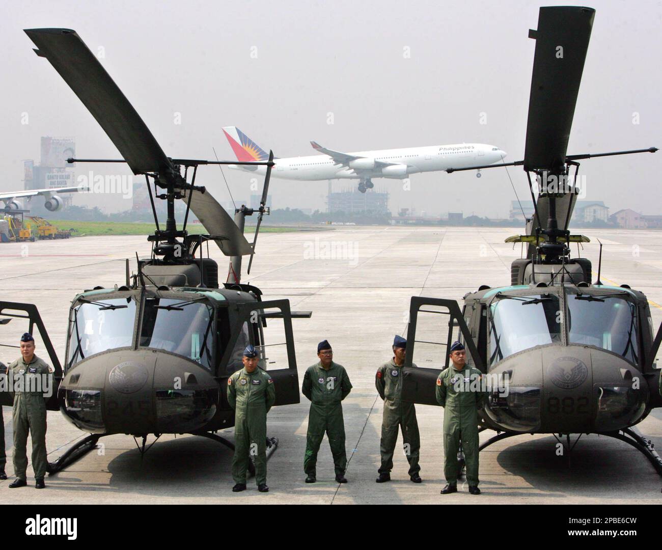 Helicopter crew stand beside the newly-acquired choppers during its ...