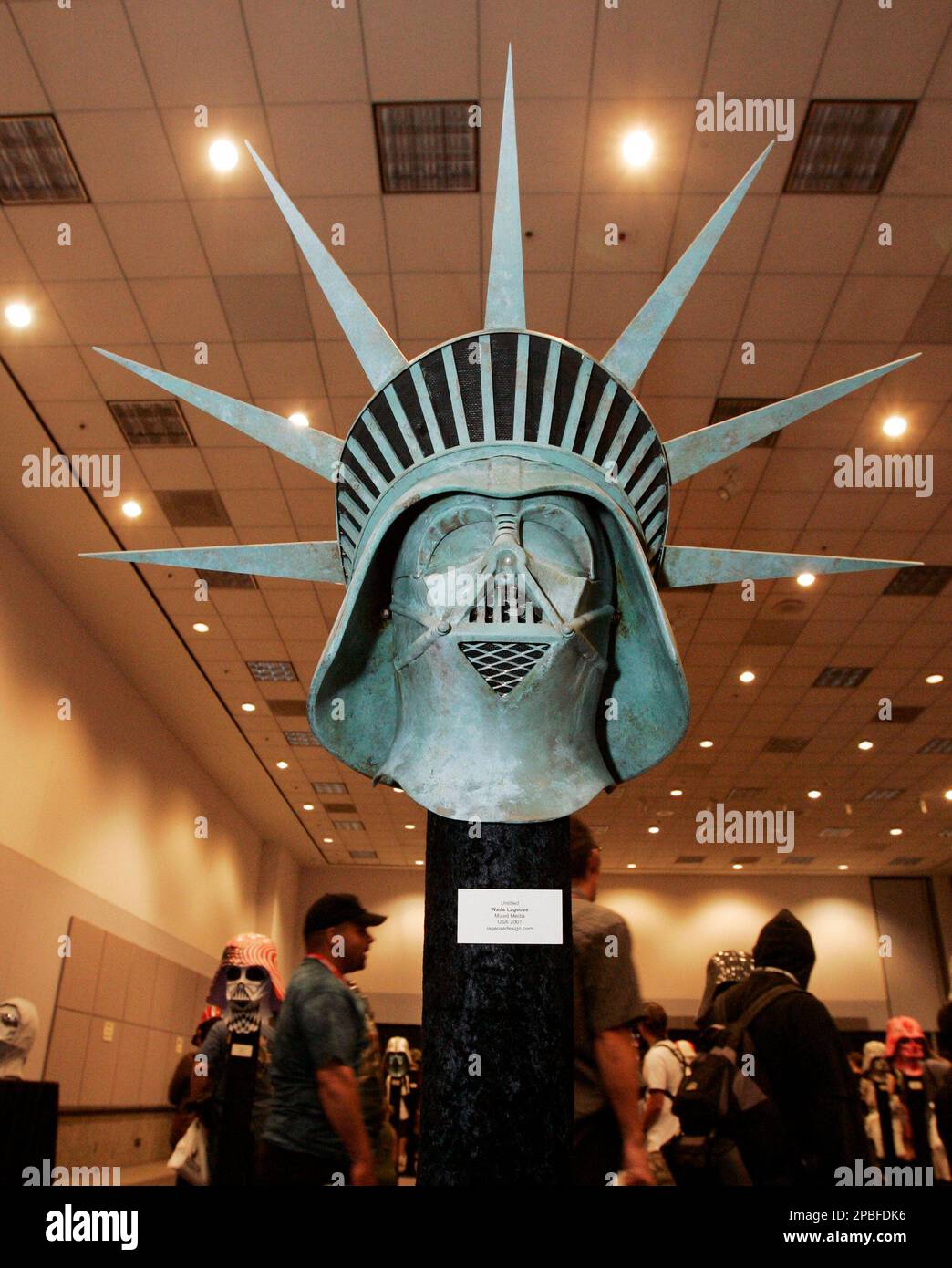 An exhibit showing a Darth Vader helmet transformed into the Statue of ...