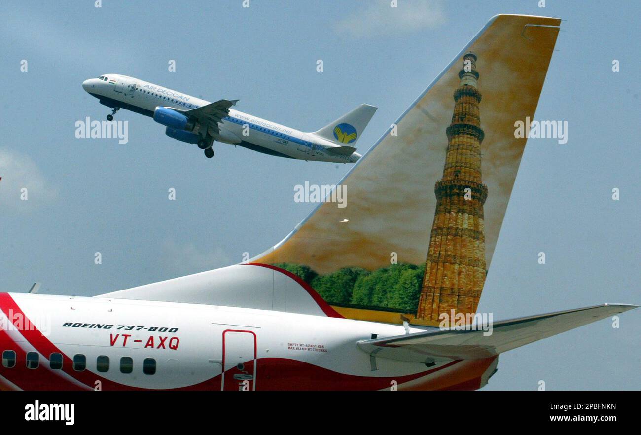 An aircraft takes off above an Air India Express's newly acquired ...