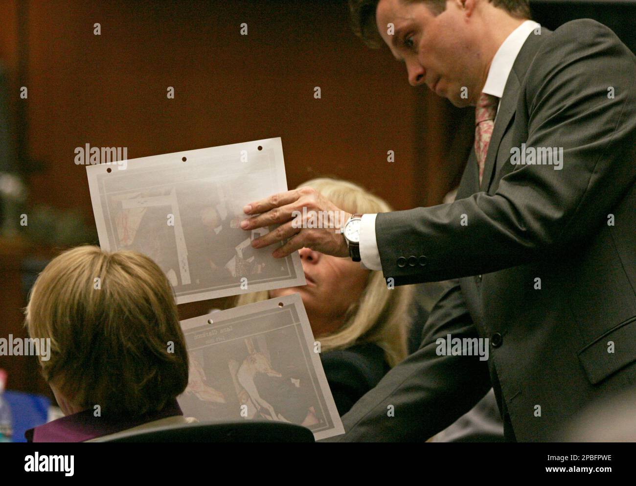 Lead prosecutor Alan Jackson, right, shows evidence photos at the crime ...